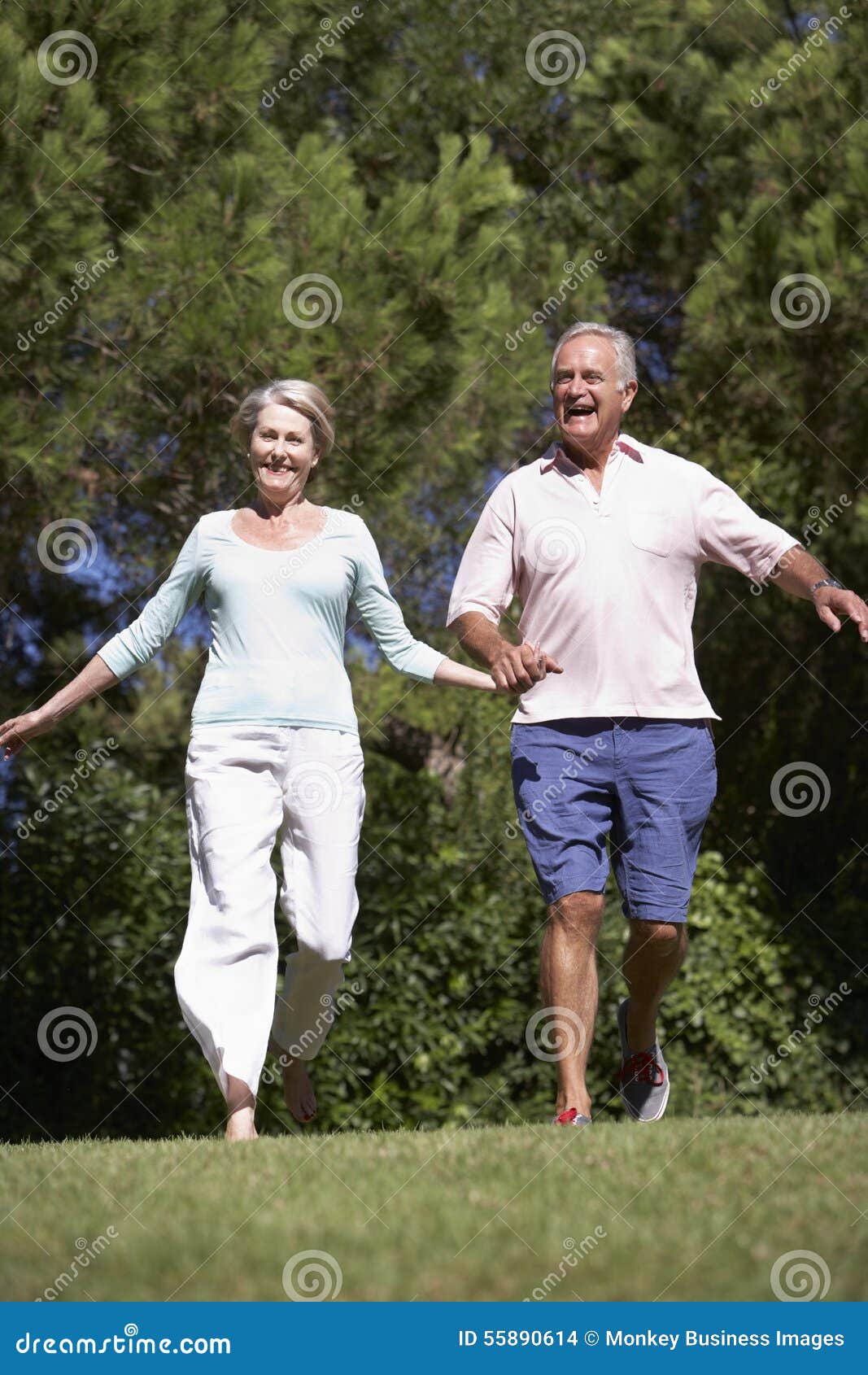 Senior Couple Running through Summer Field Stock Photo - Image of field ...