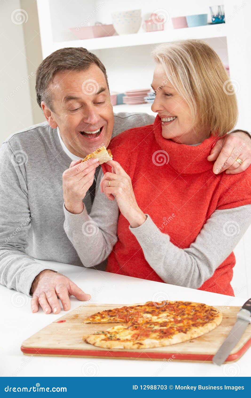 Senior Couple Sharing Takeaway Pizza in Kitchen Stock Image - Image of ...