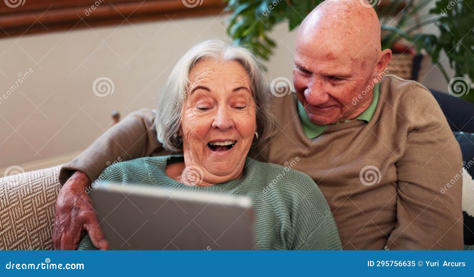Senior Couple Tablet And Laugh In Home While Reading Social Media Post