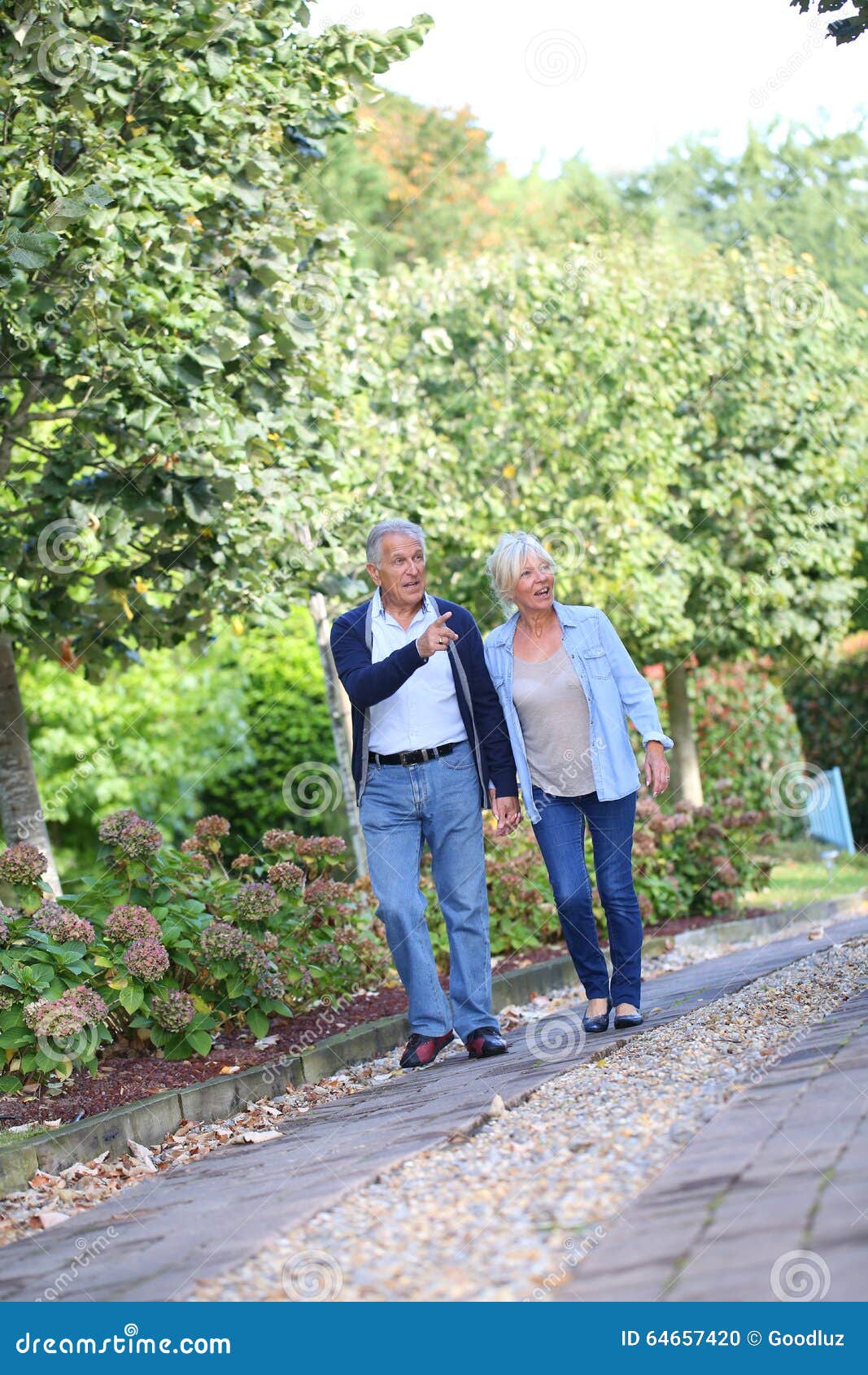 Senior Couple Taking a Walk in Park Stock Photo - Image of hugging ...