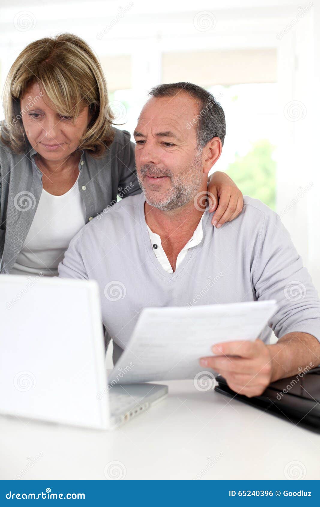 Senior Couple Using Laptop Doing Paperwork Stock Photo - Image of ...