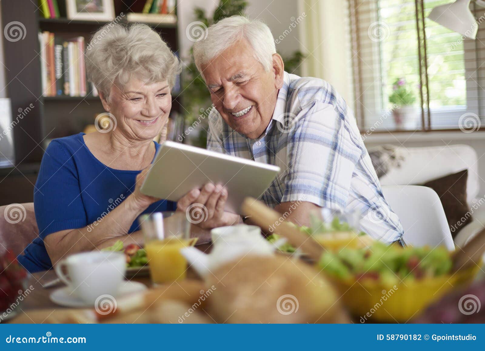 Senior couple using tablet stock photo. Image of browsing - 58790182