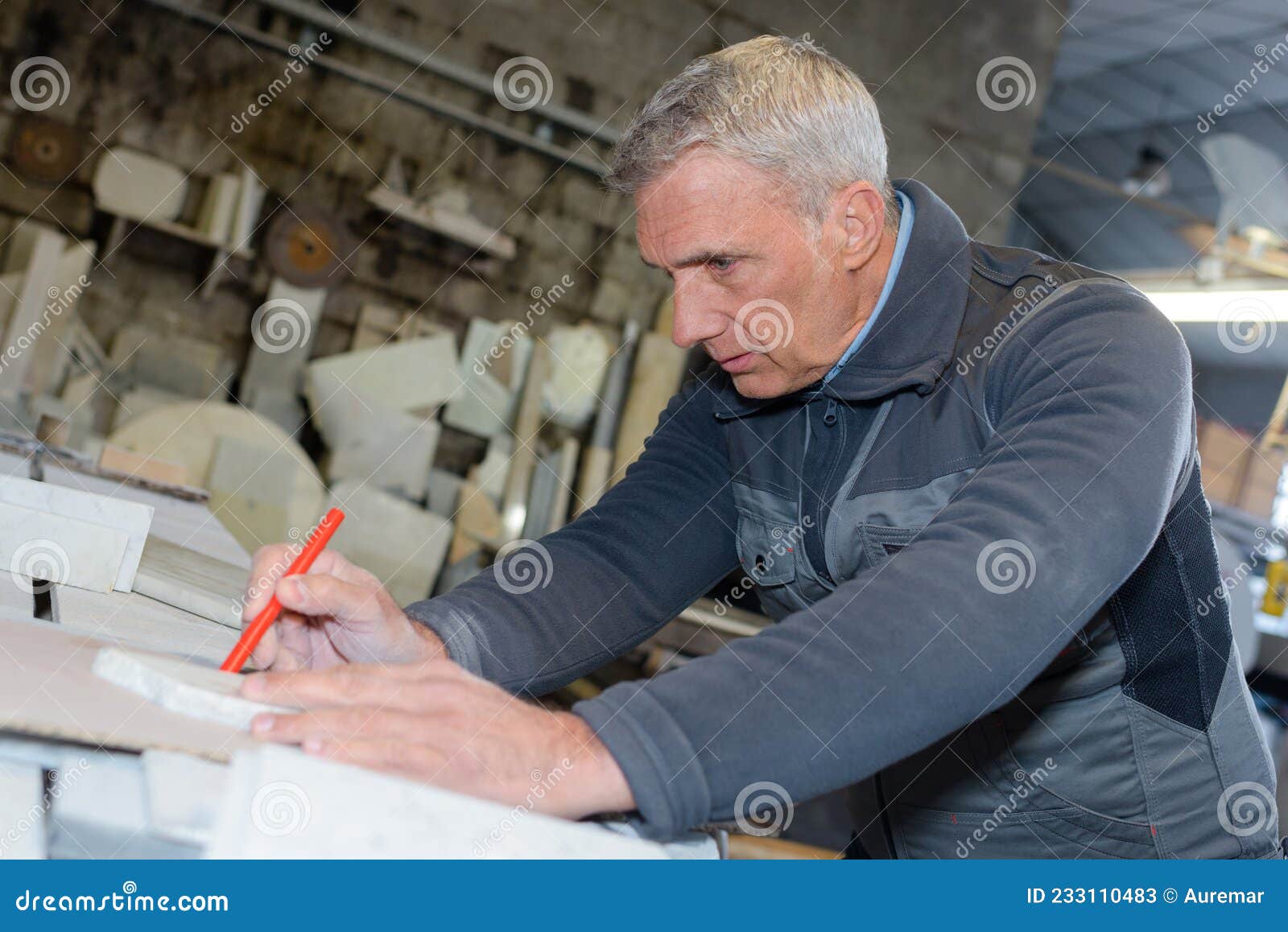 A Marking The Tiles With A Yellow Ruler And A Pencil For Cutting With ...