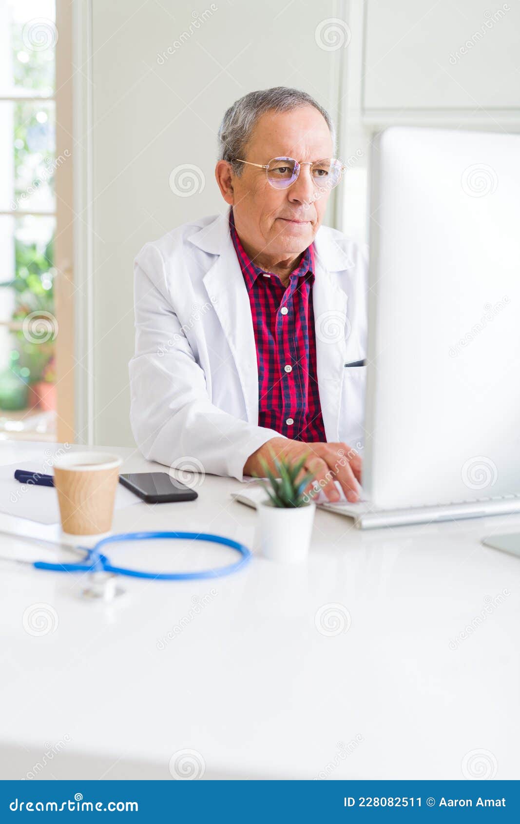 Senior Doctor Man at the Clinic Concentrated Working with Computer ...