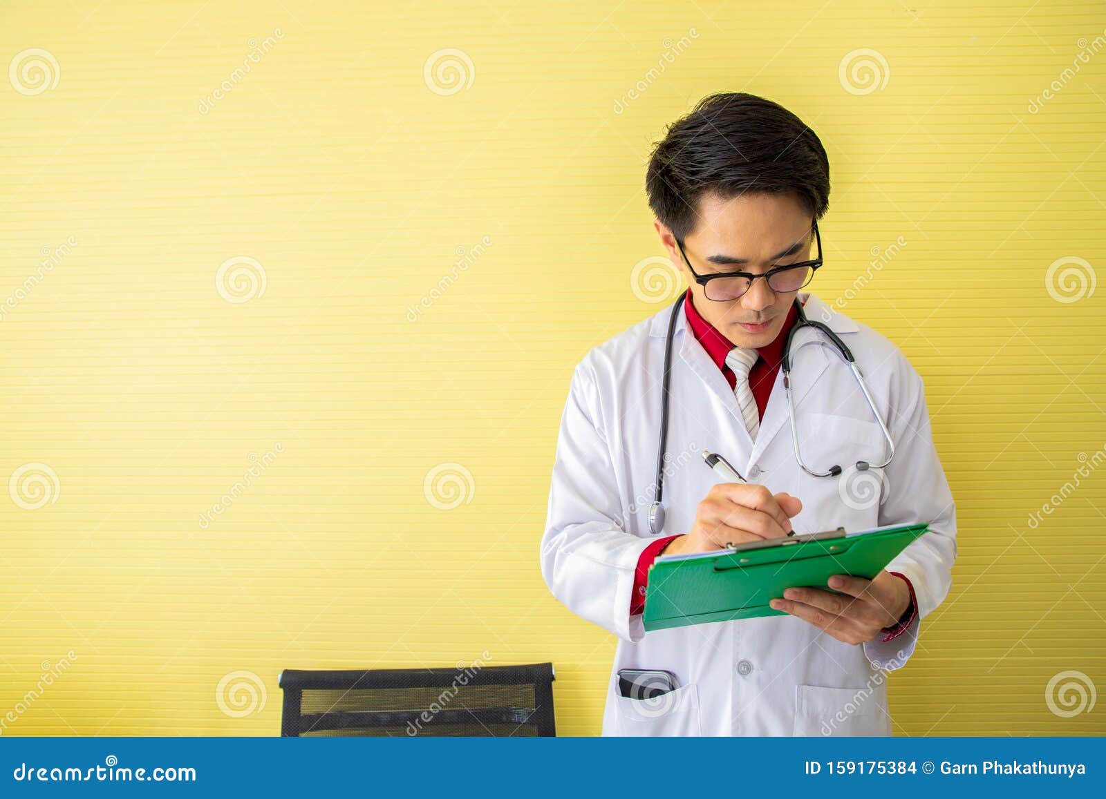 Senior Doctor Reading and Writing Patient Profile Stock Photo - Image ...