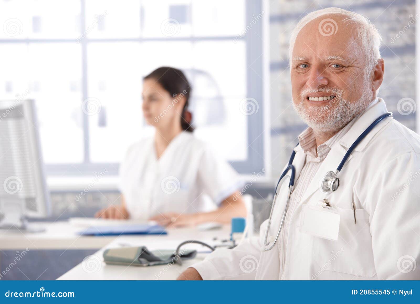 Senior Doctor Sitting at Desk Smiling Stock Image - Image of indoor ...