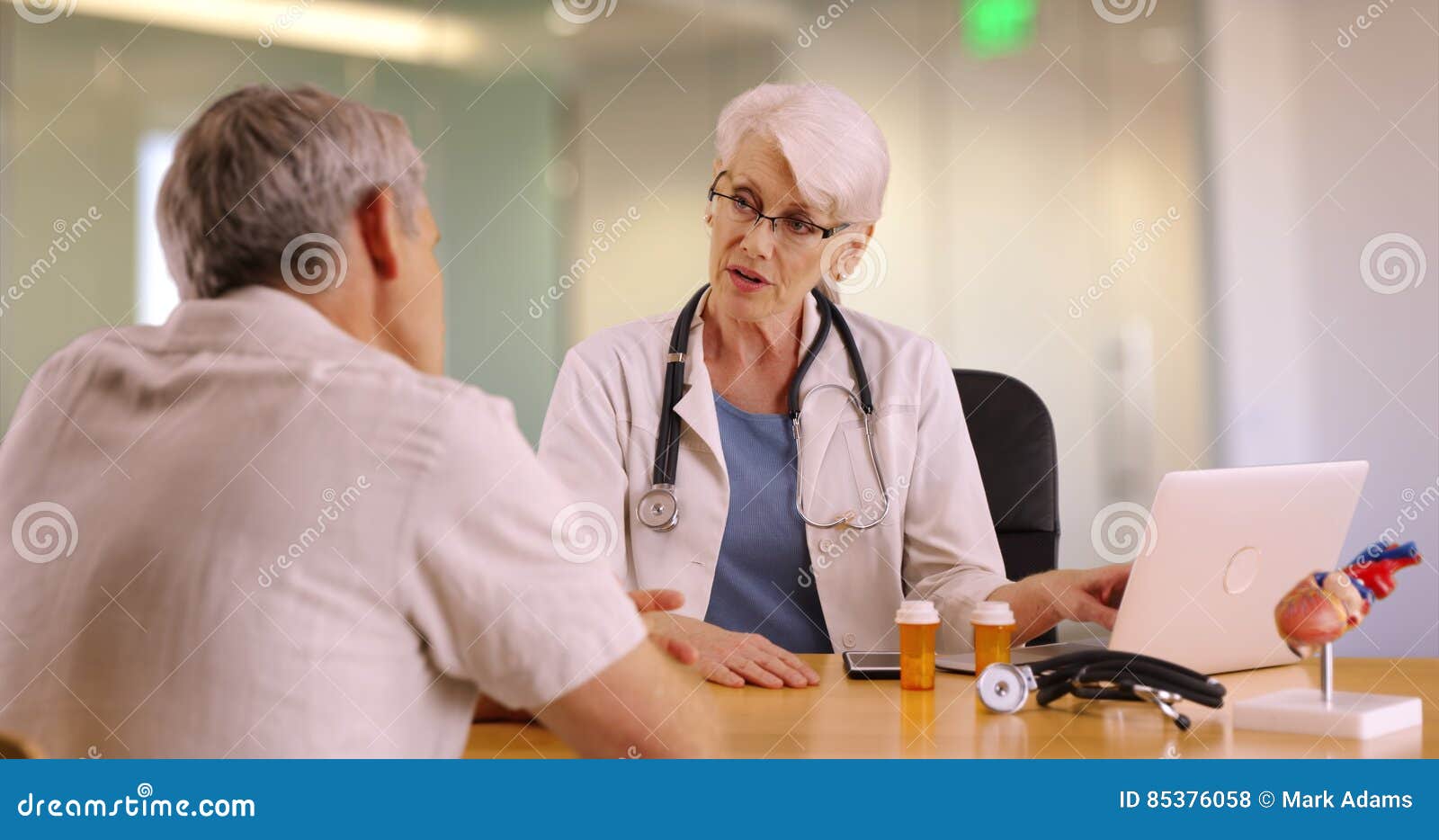 Senior Doctor Talking with Elderly Man in the Office Stock Photo ...