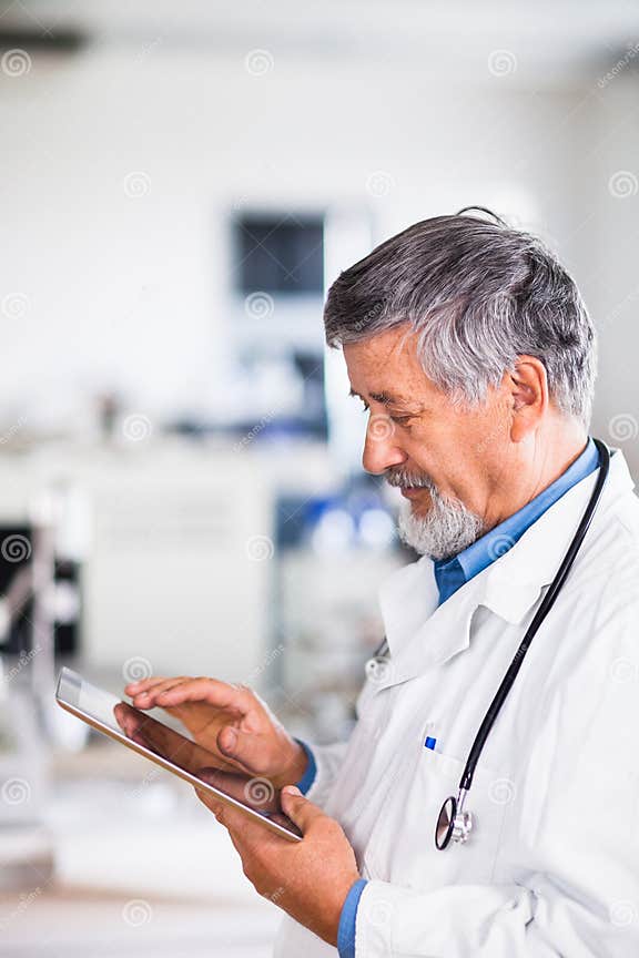 Senior Doctor Using His Tablet Computer Stock Image - Image of hospital ...