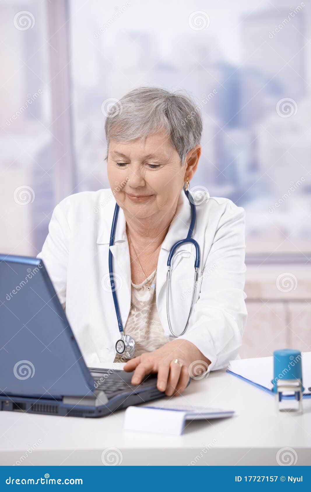 Senior Doctor Using Laptop Computer Stock Image - Image of female, gray ...