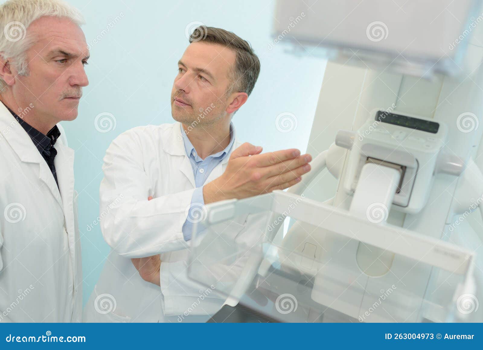 Senior Doctors Discussing Next To Machine in Hospital Stock Image ...