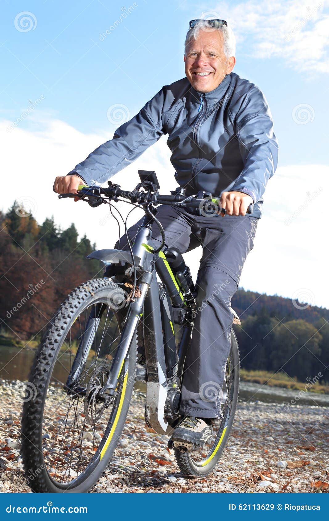 Senior on E-mountain Bike beside a River Stock Image - Image of motor ...