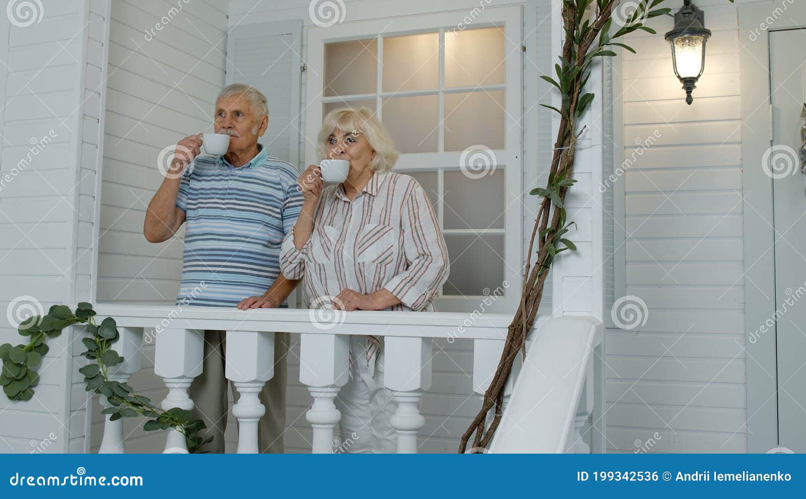 Senior Elderly Caucasian Couple Drinking Coffee Embracing In Porch At
