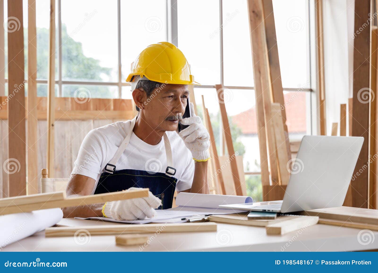 Senior Engineer or Carpenter Look at Laptop Computer. Stock Image ...
