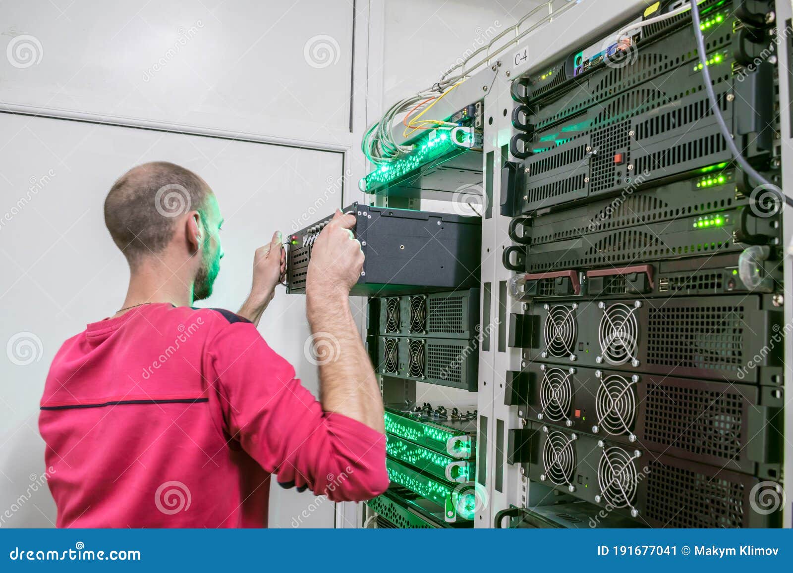 Senior Engineer Takes the Server Out of the Rack with Computer ...