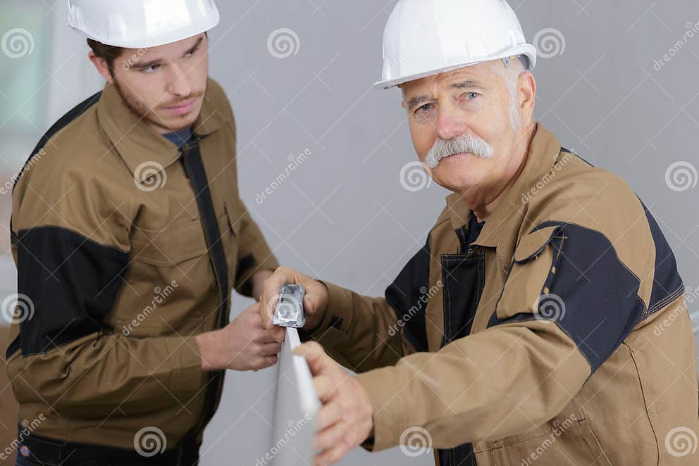 Senior Foreman with Younger Worker Stock Photo - Image of looking ...
