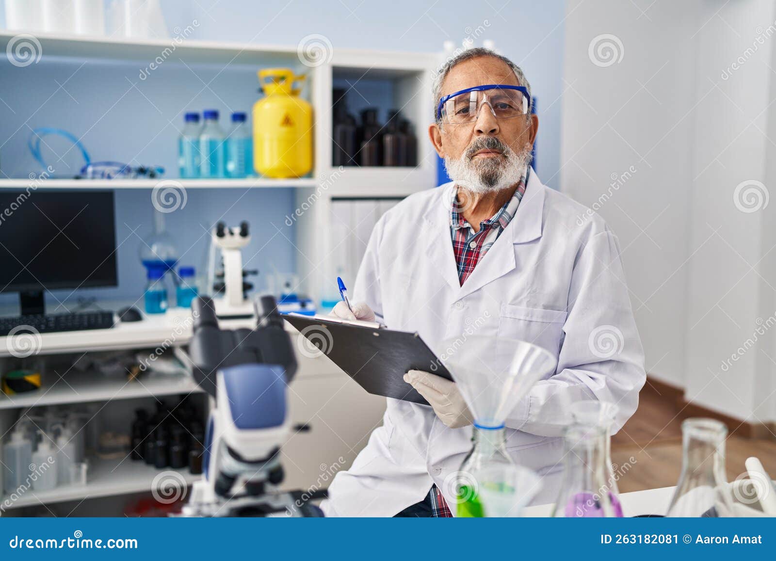 Senior Grey-haired Man Scientist Writing Report Working at Laboratory ...