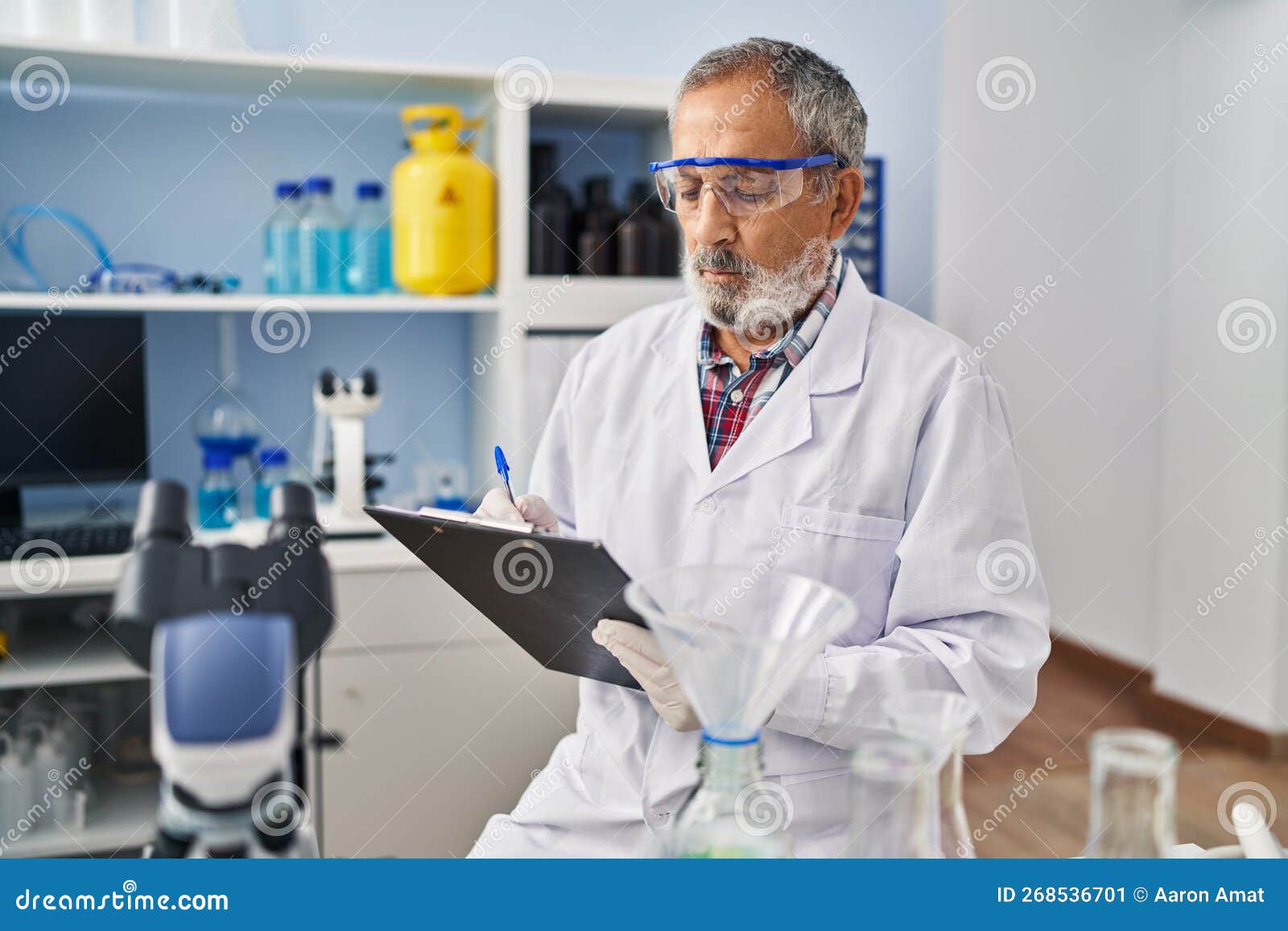 Senior Grey-haired Man Scientist Writing Report Working at Laboratory ...