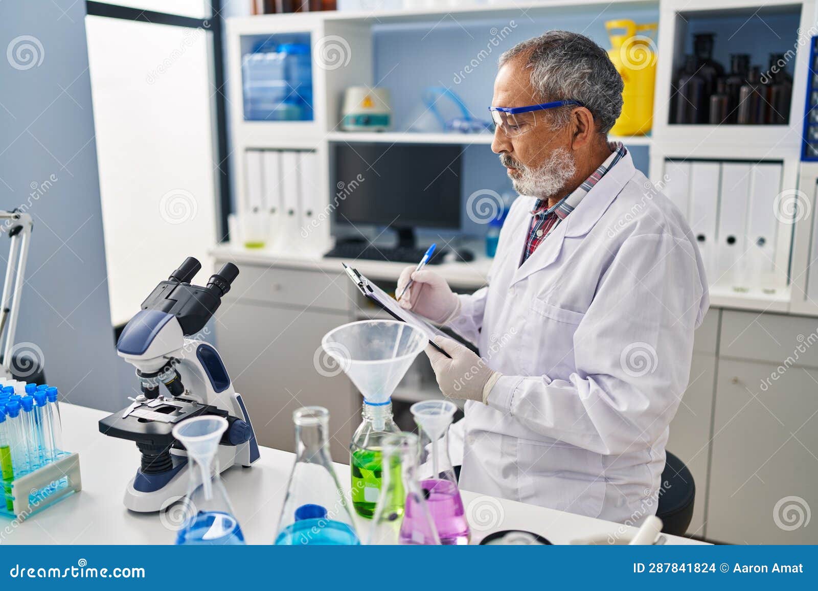 Senior Grey-haired Man Scientist Writing Report Working at Laboratory ...