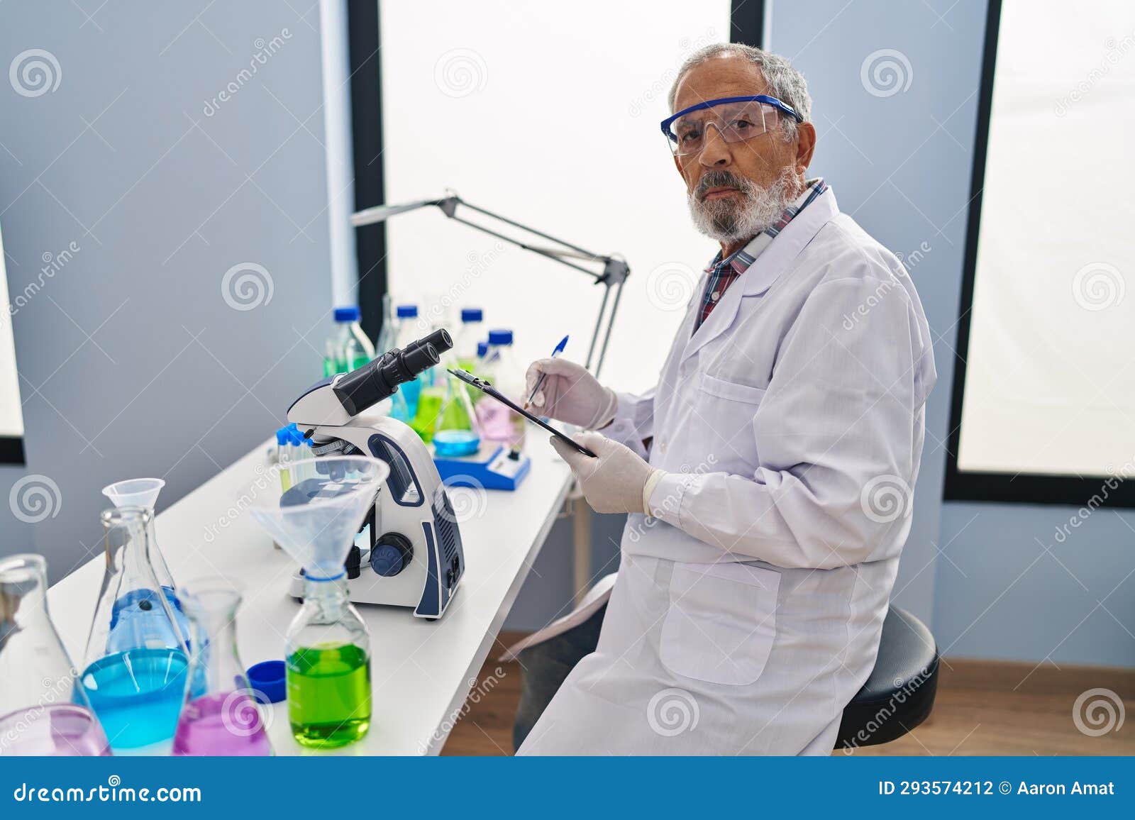 Senior Grey-haired Man Scientist Writing Report Working at Laboratory ...