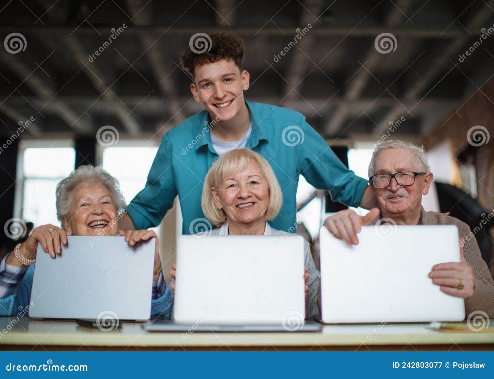 Senior Group in Retirement Home with Young Instructor Learning Together ...