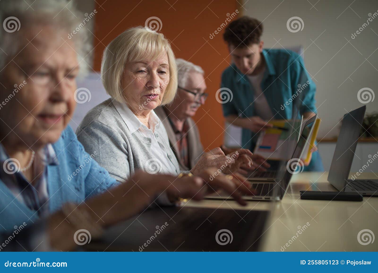 Senior Group with Young Instructor Learning Together in Computer Class ...