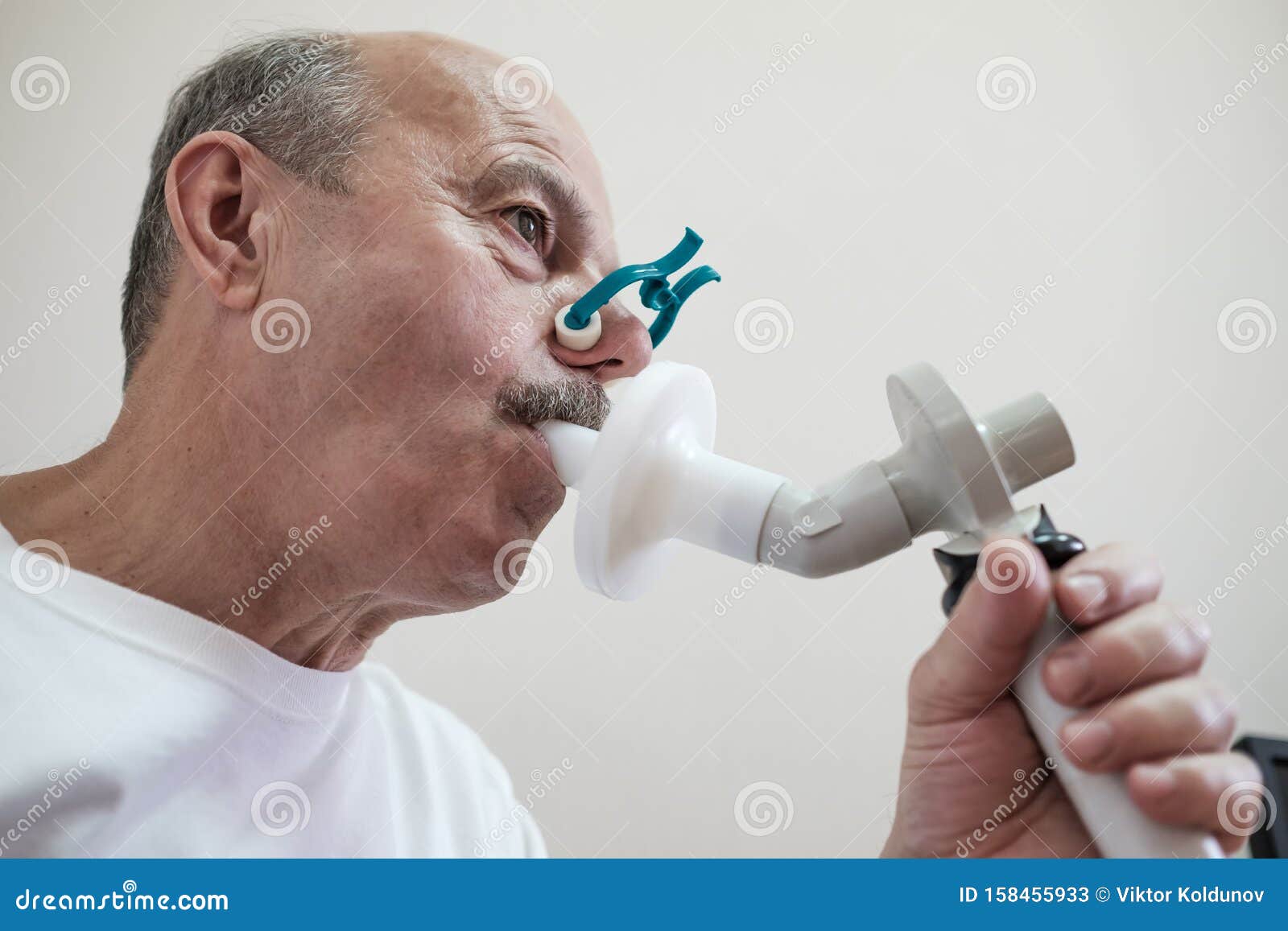 Senior Hispanic Man Man Testing Breathing Function by Spirometry Stock ...