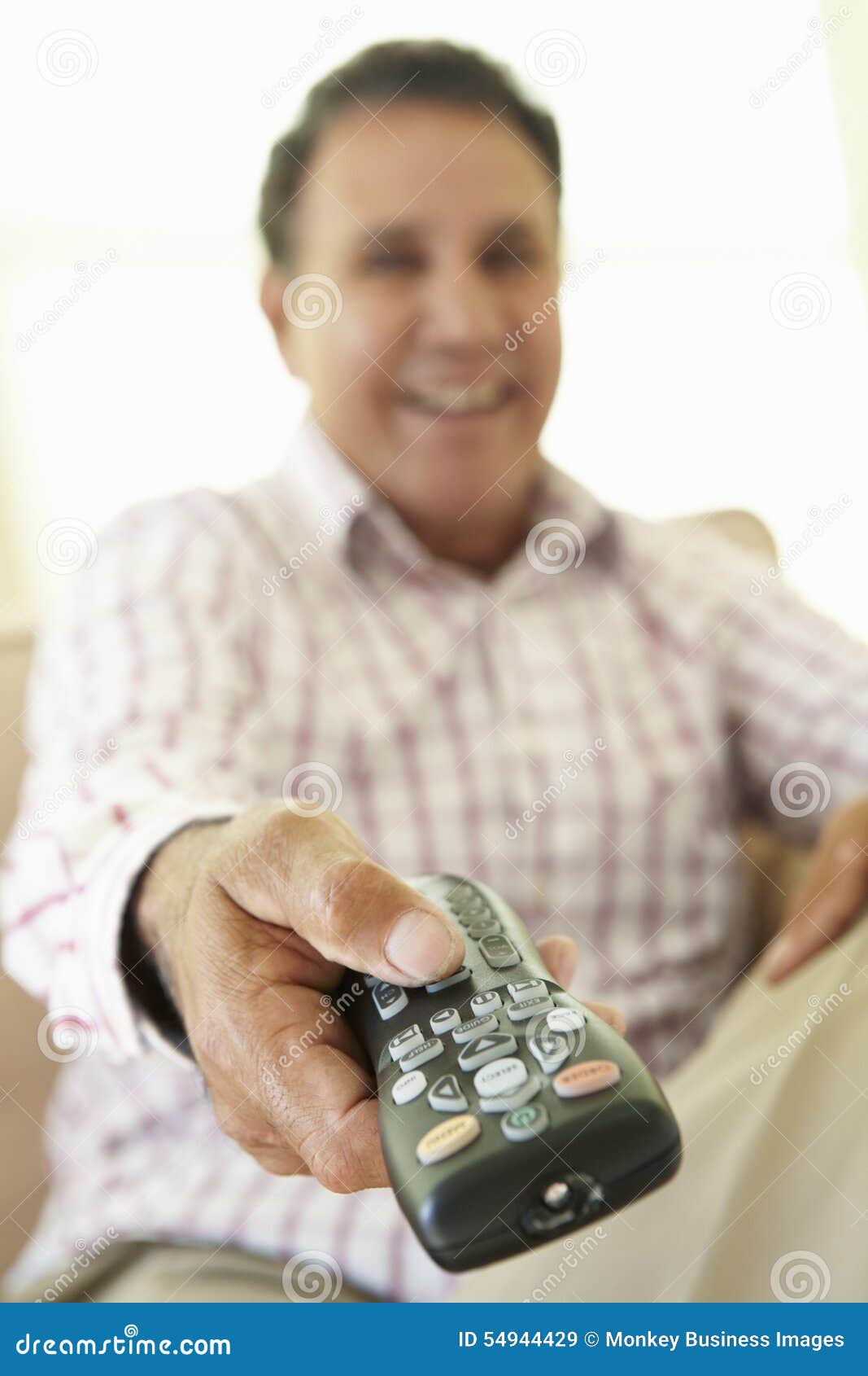 Senior Hispanic Man Using TV Remote Control Stock Image - Image of ...