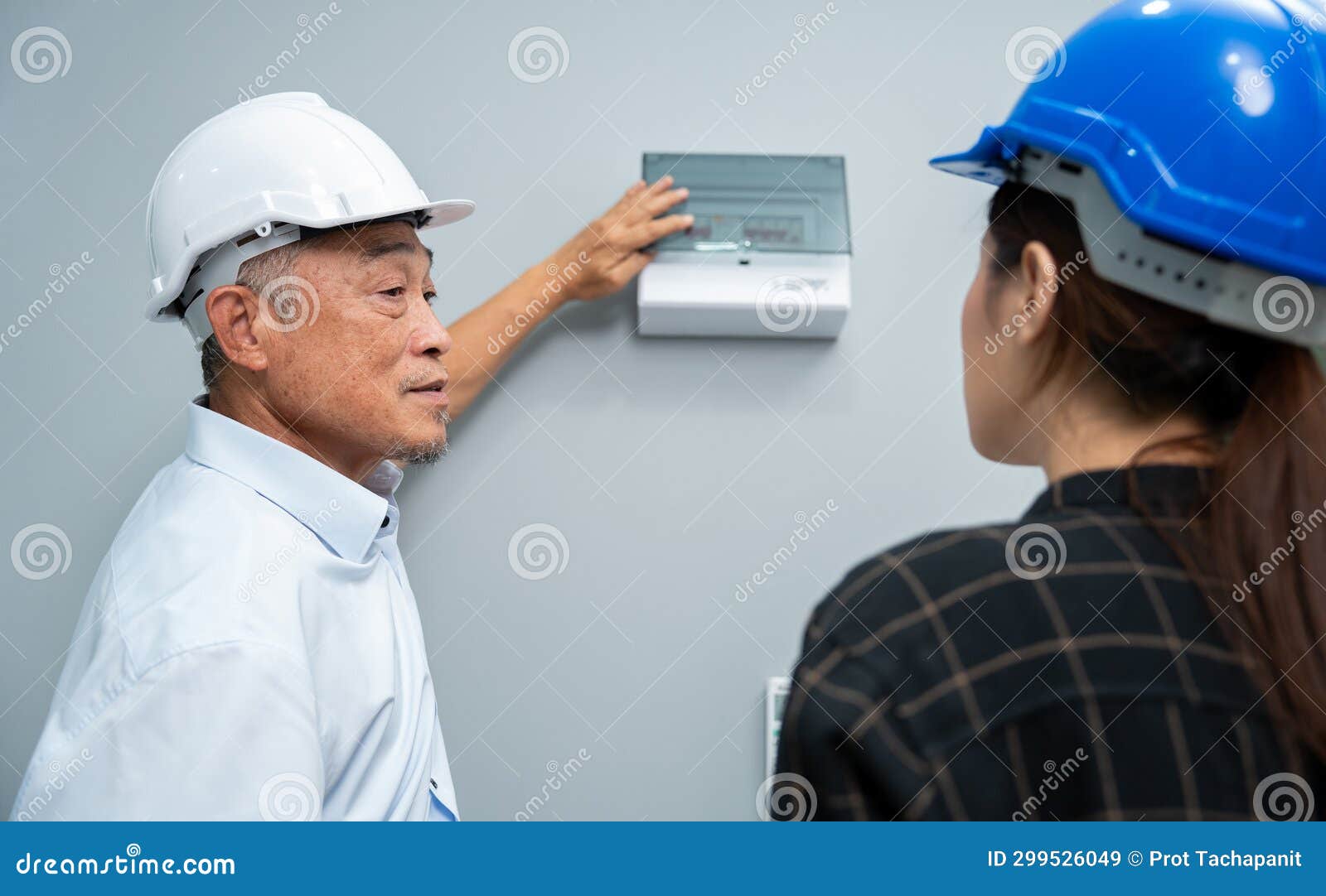 Senior Home Inspector Checking Home Defects and Teaching Young ...