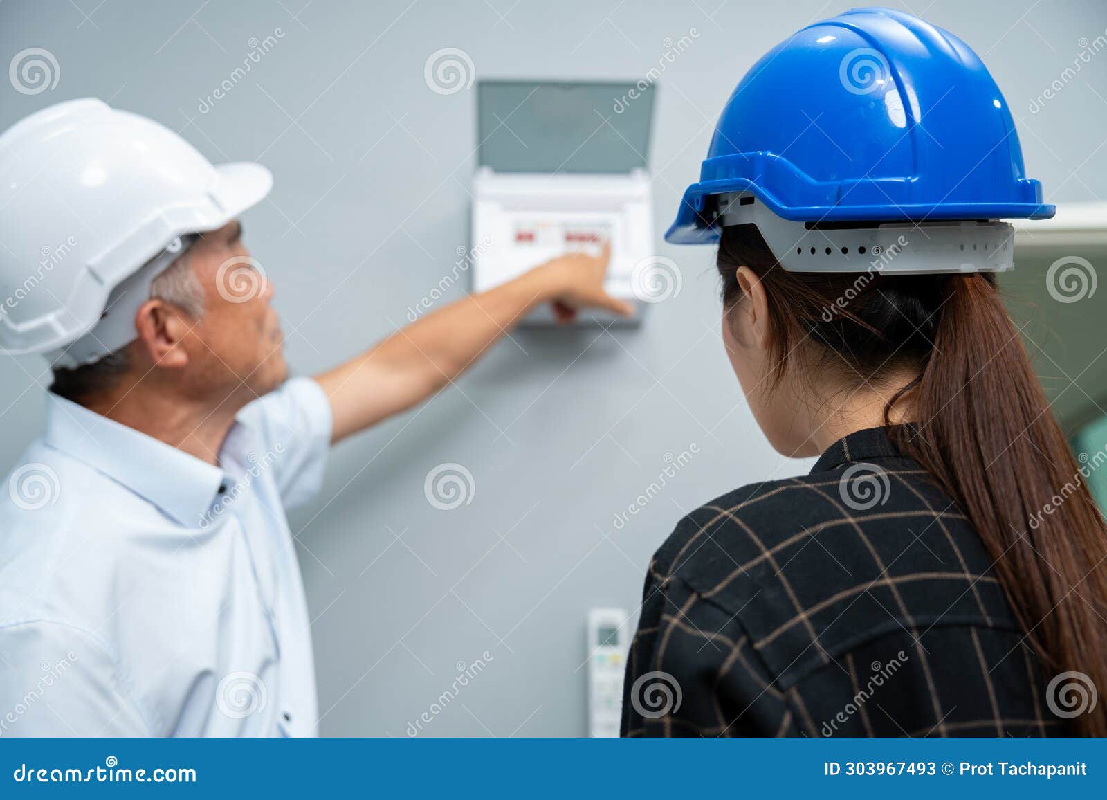 Senior Home Inspector Checking Home Defects and Teaching Young ...
