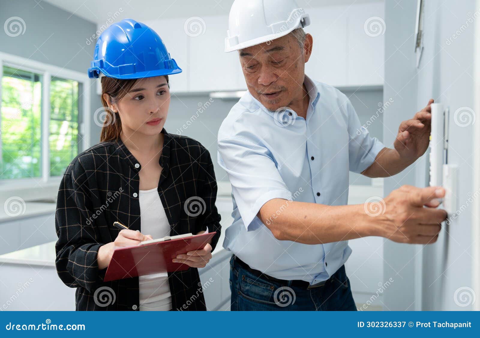 Senior Home Inspector Checking the Electrical Switch and Check Defects ...