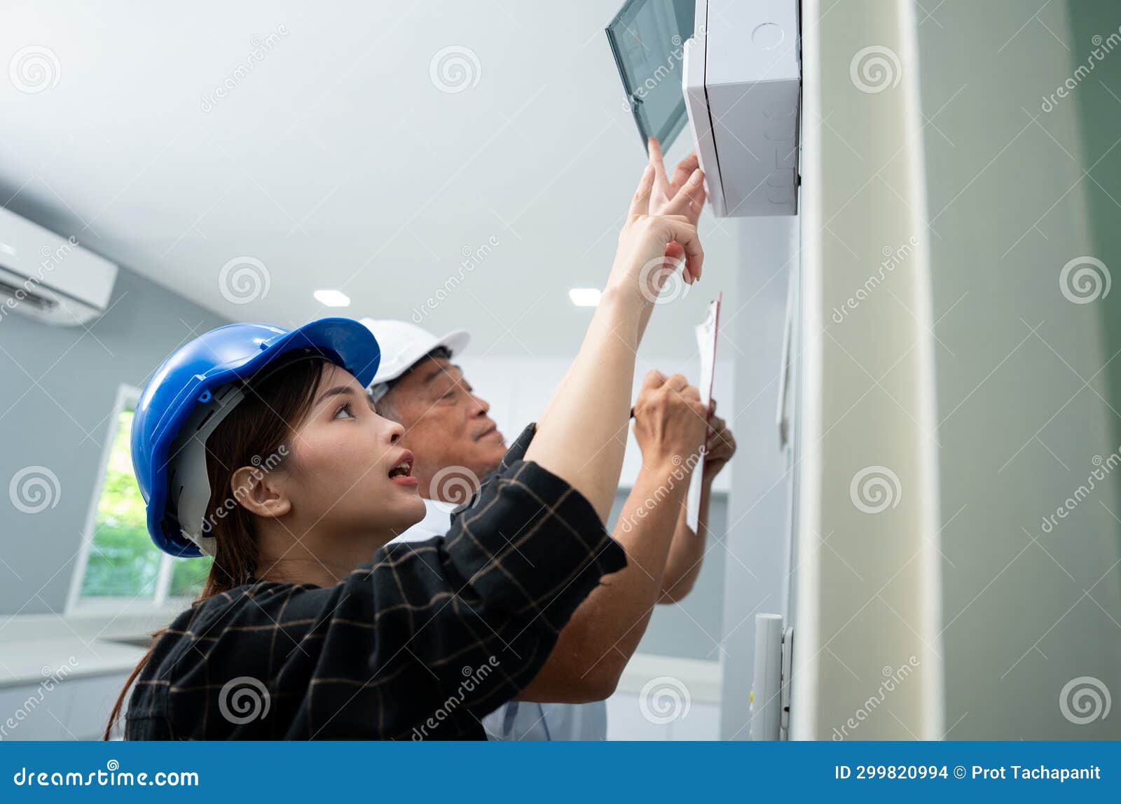 Senior Home Inspector Checking Home Defects and Teaching Young ...
