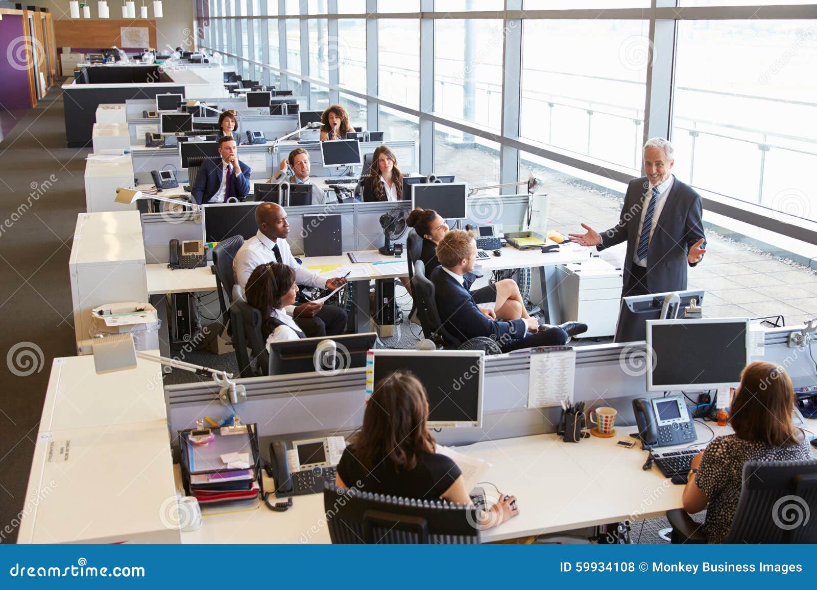 Senior Male Manager Addressing Workers in Open Plan Office Stock Photo ...