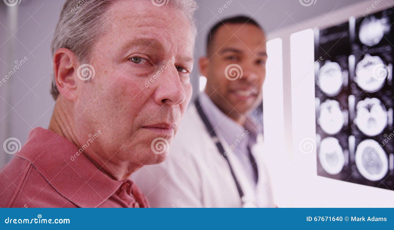 Senior Male Patient Looking at Camera with Young Medical Practitioner ...