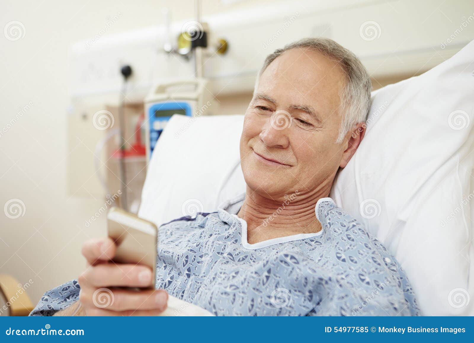 Senior Male Patient Using Mobile Phone in Hospital Bed Stock Image ...
