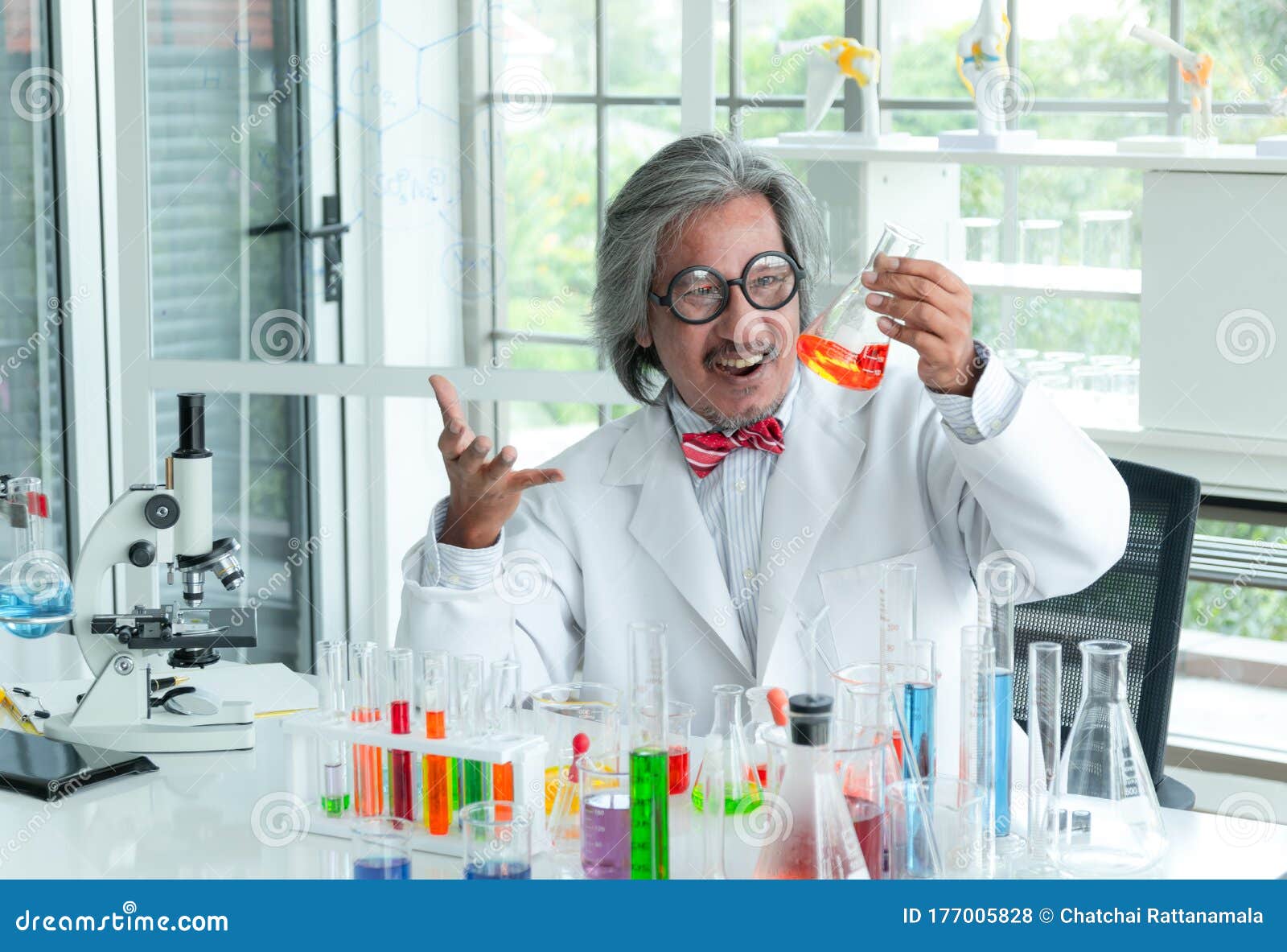 Senior Male Supervisor Doing Experiments and Researchers Working in the ...