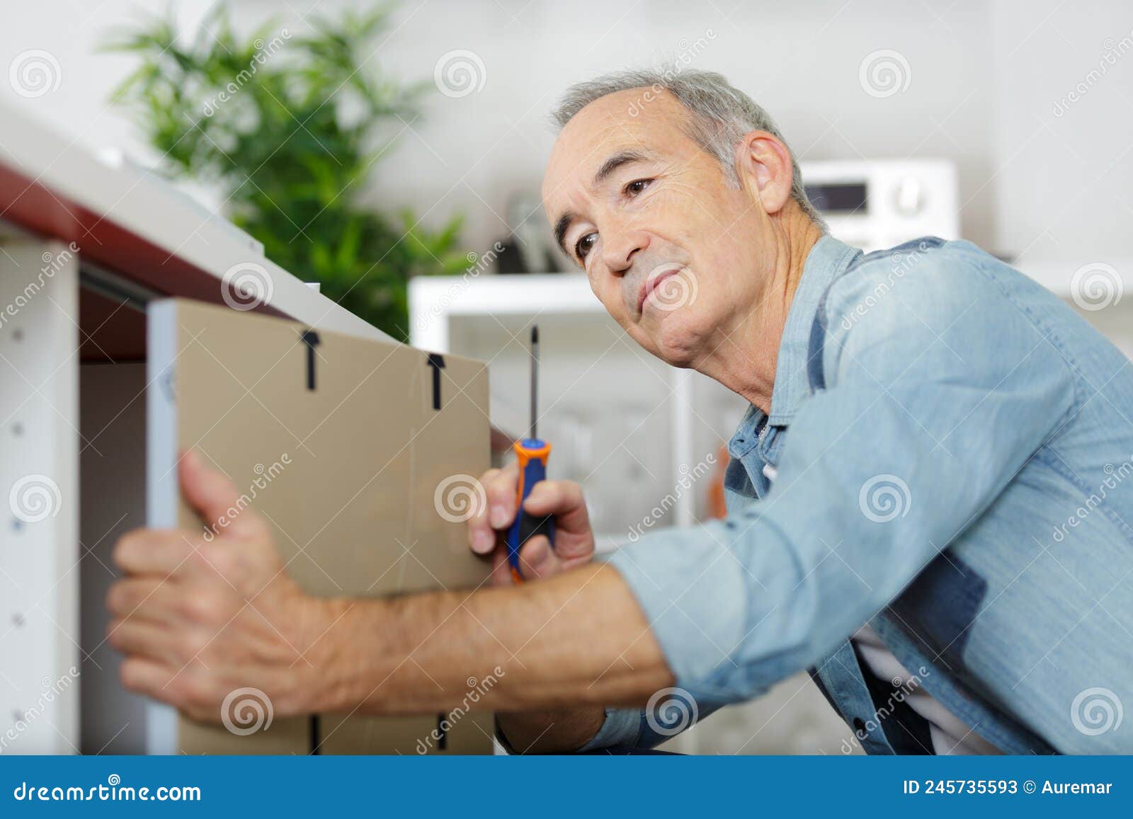 Senior Man Assembling Kitchen Cupboard Stock Image - Image of handyman ...