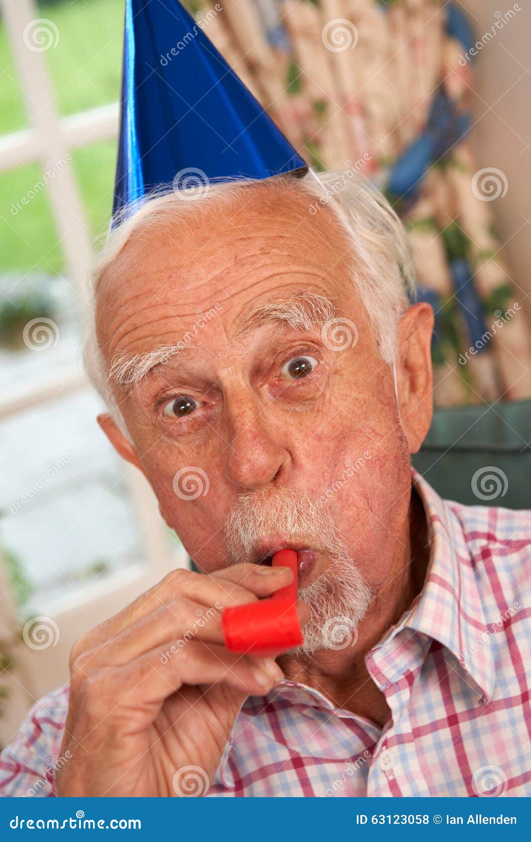Senior Man Celebrating with Party Hat and Blower Stock Photo - Image of ...