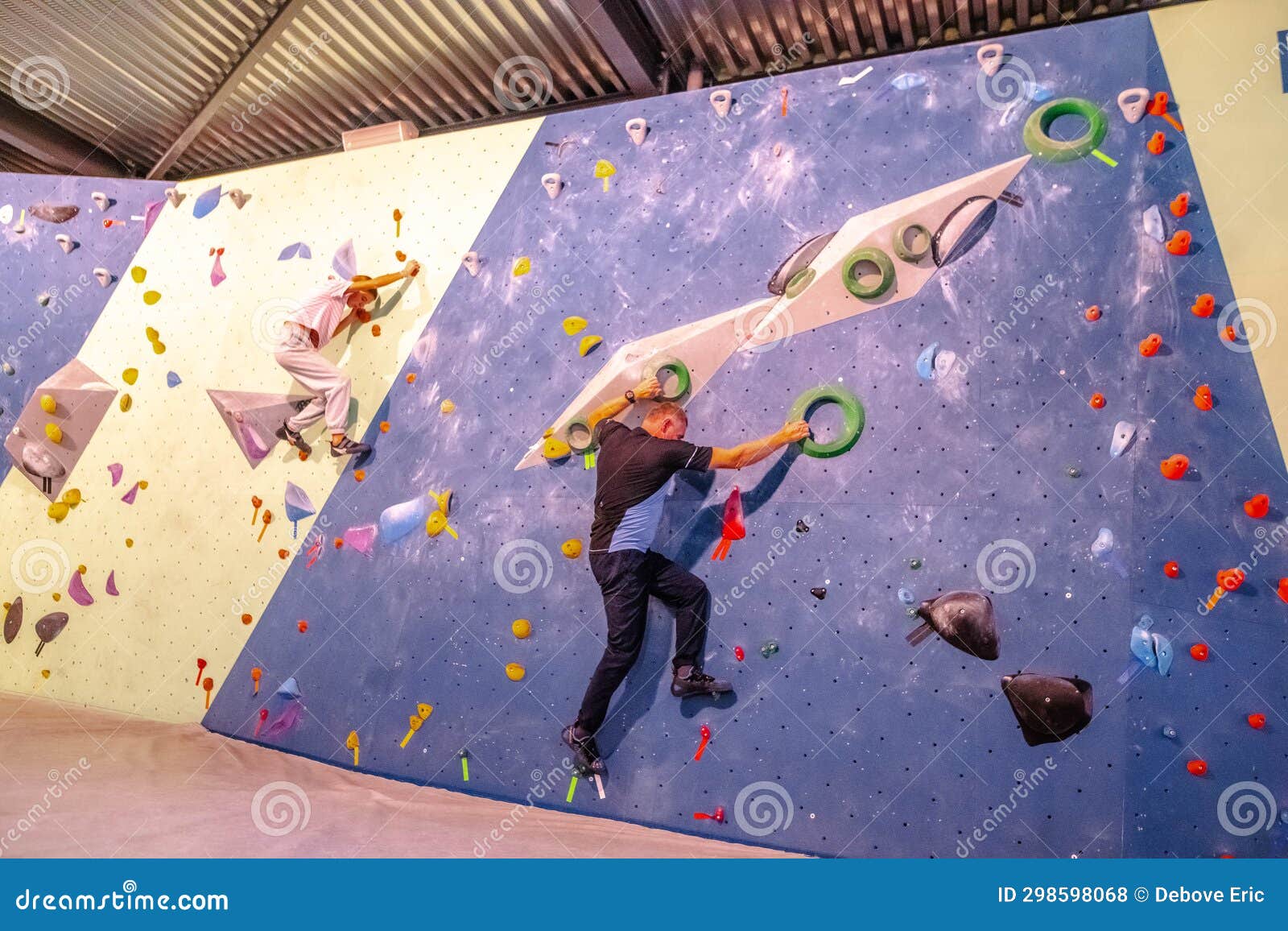 Middle-aged or Senior Man Climbing on a Climbing Wall in a Gym Stock ...
