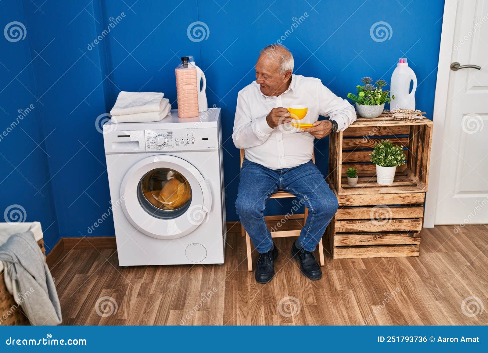 Senior Man Drinking Coffee Waiting for Washing Machine at Laundry Room ...