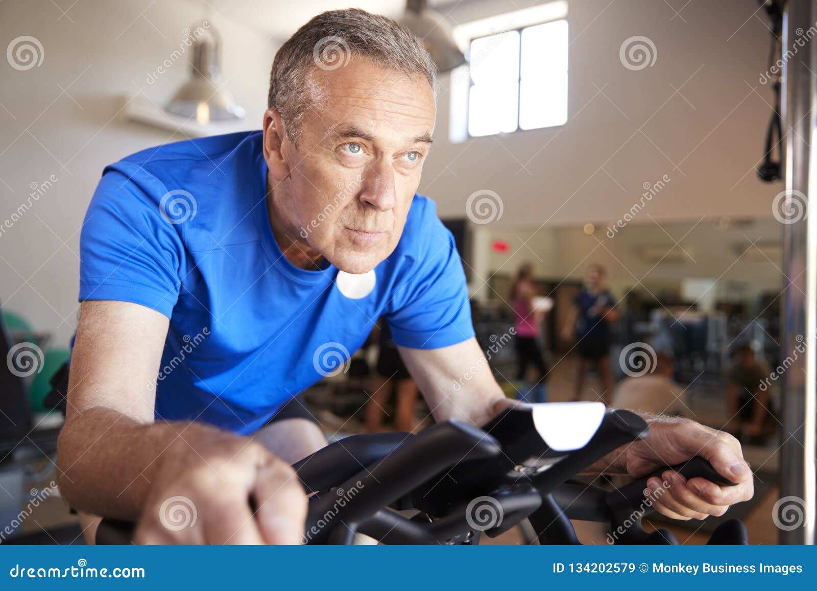 Senior Man Exercising on Cycling Machine in Gym Stock Image - Image of ...