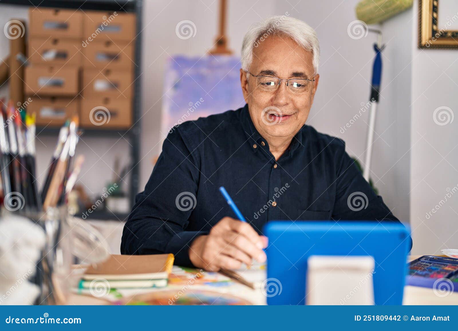 Senior Man Having Online Draw Lesson Sitting on Table at Art Studio ...