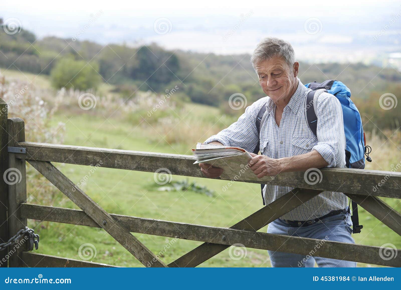 Senior Man Hiking in Countryside Resting by Gate Stock Photo - Image of ...