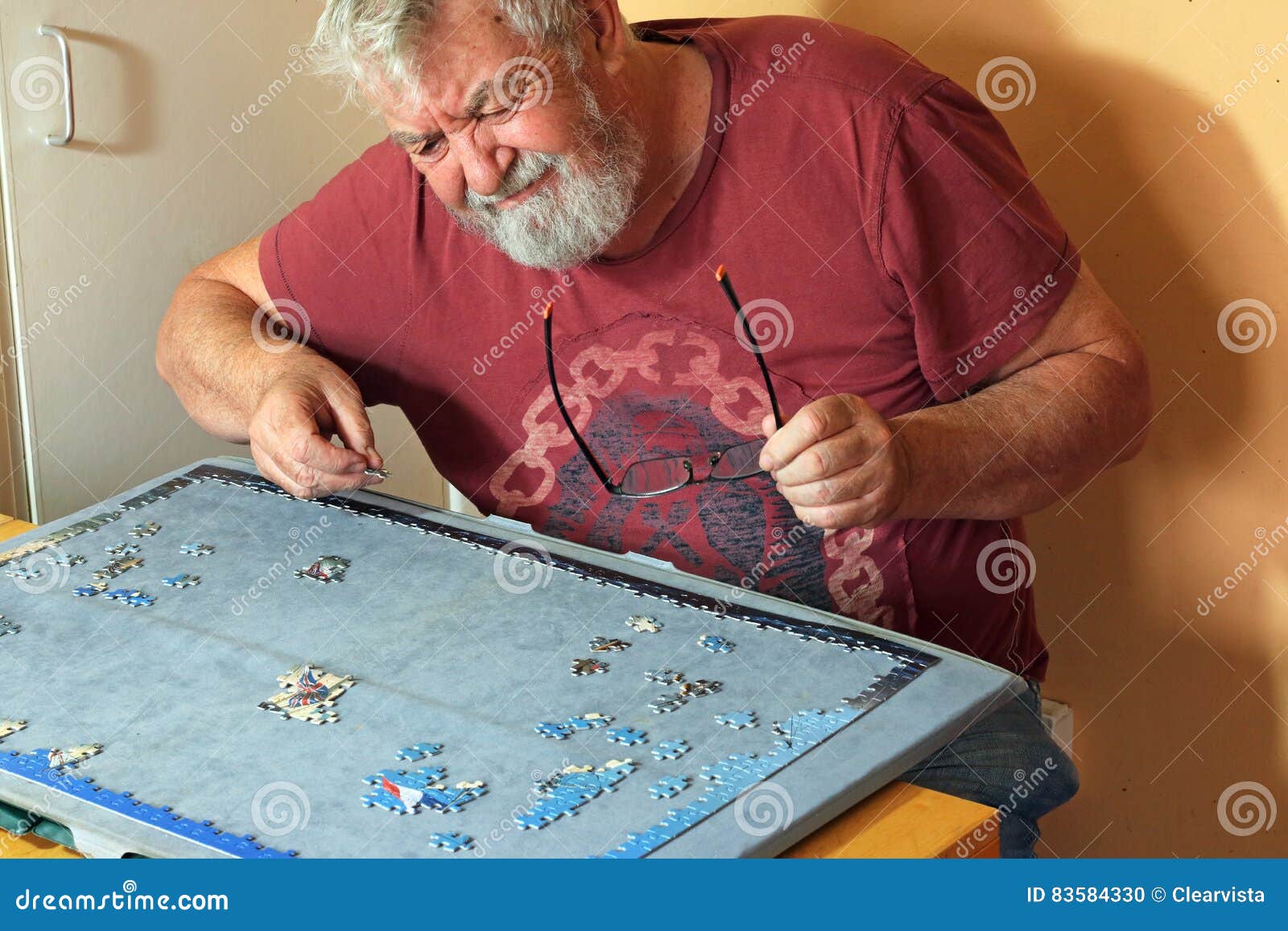 Senior Man on His Own Difficult Doing a Jigsaw Puzzle. Stock Photo ...