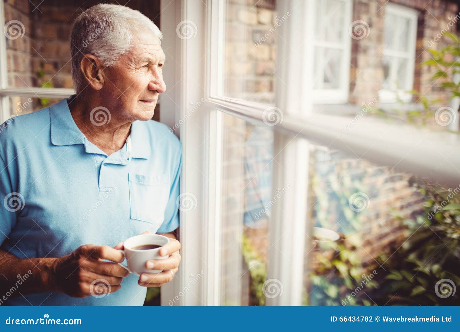 Senior Man Holding Cup and Looking Out of the Window Stock Photo ...
