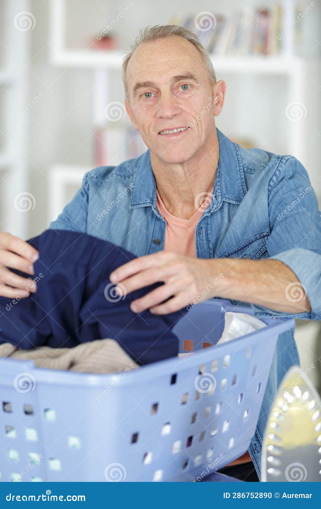 Senior Man Holding Folding Laundry Clothes Stock Photo - Image of ...