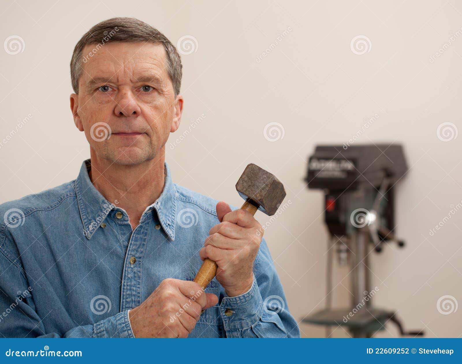 Senior Man Holding A Large Hammer Stock Photography - Image: 22609252
