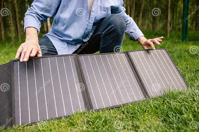 Senior Man Holding Solar Panel on in Green Yard. Stock Photo - Image of ...