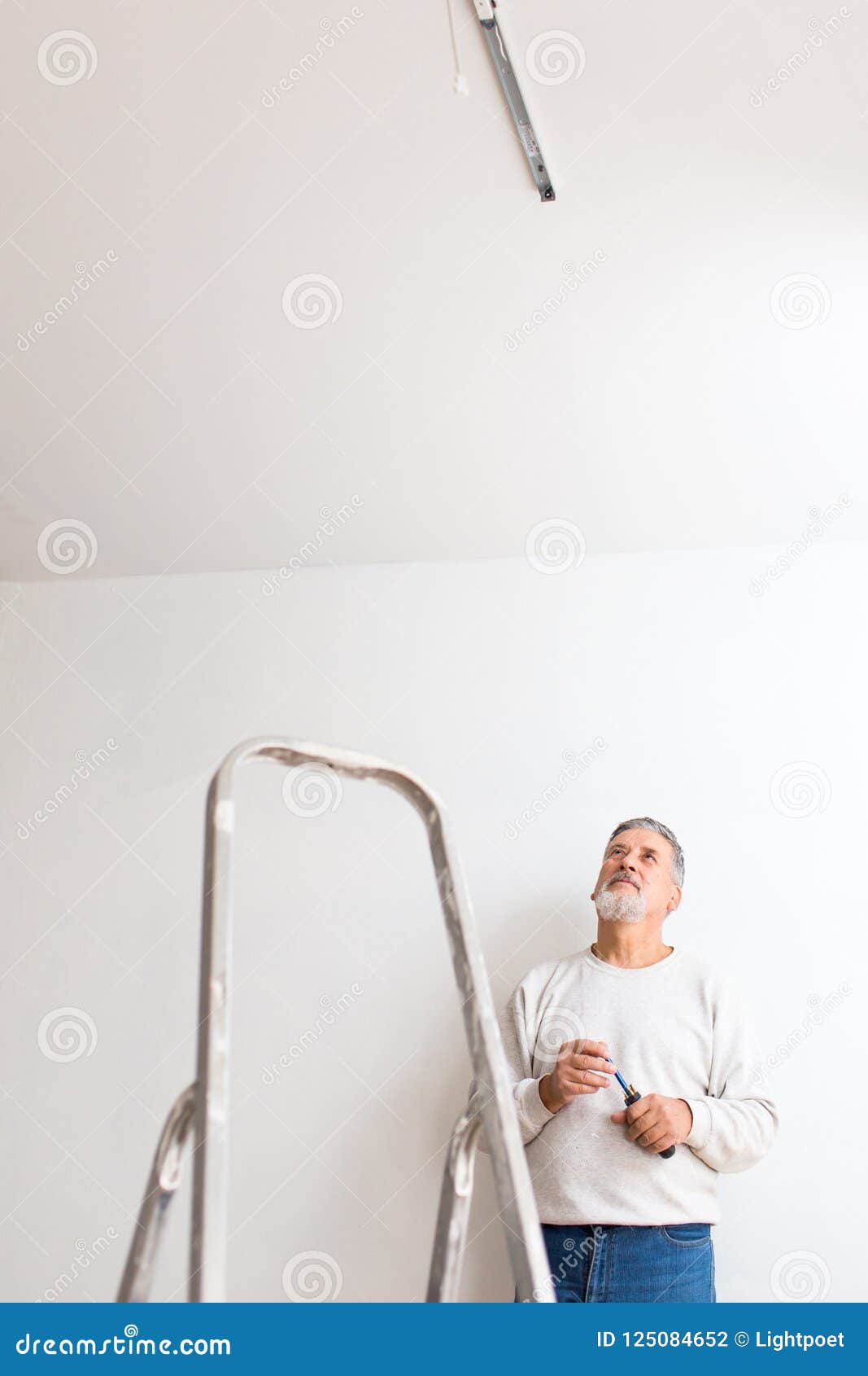 Senior Man Installing a Ceiling Light in Appartment Stock Photo - Image ...