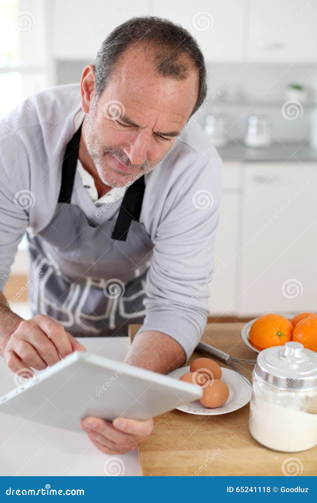 Senior Man in the Kitchen Searching for Recipe with Tablet Stock Photo ...
