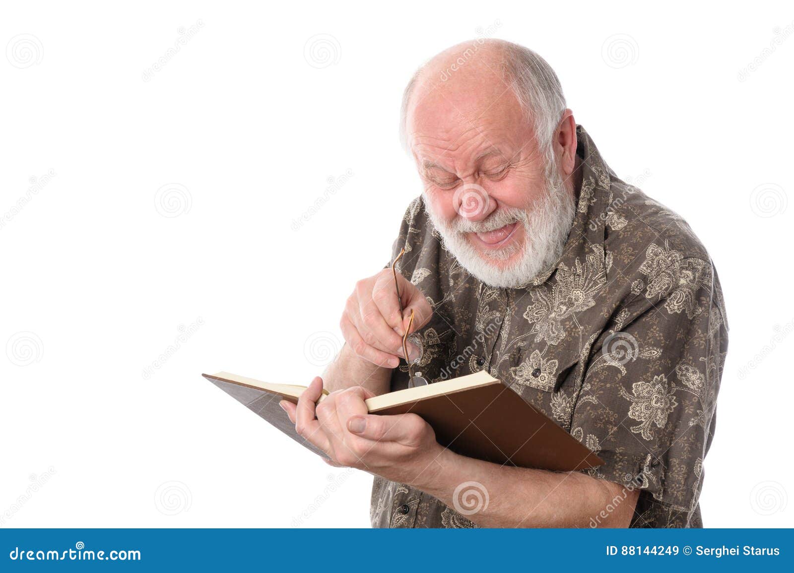Senior Man Laughing While Reading A Book Isolated On White Stock Image